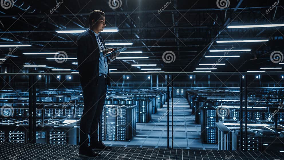 Portrait of it Specialist Using Tablet Computer in Data Center. Big ...
