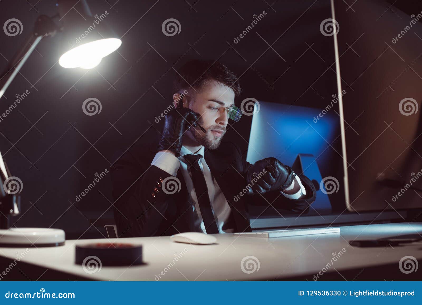 Portrait of Spy Agent in Gloves with Headset Checking Time at Table ...