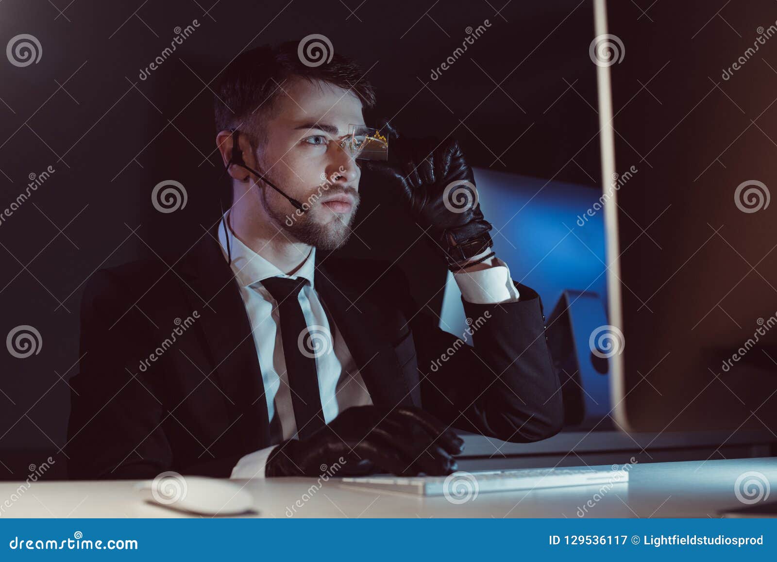 Portrait of Spy Agent with Headset Looking at Computer Screen at Table ...