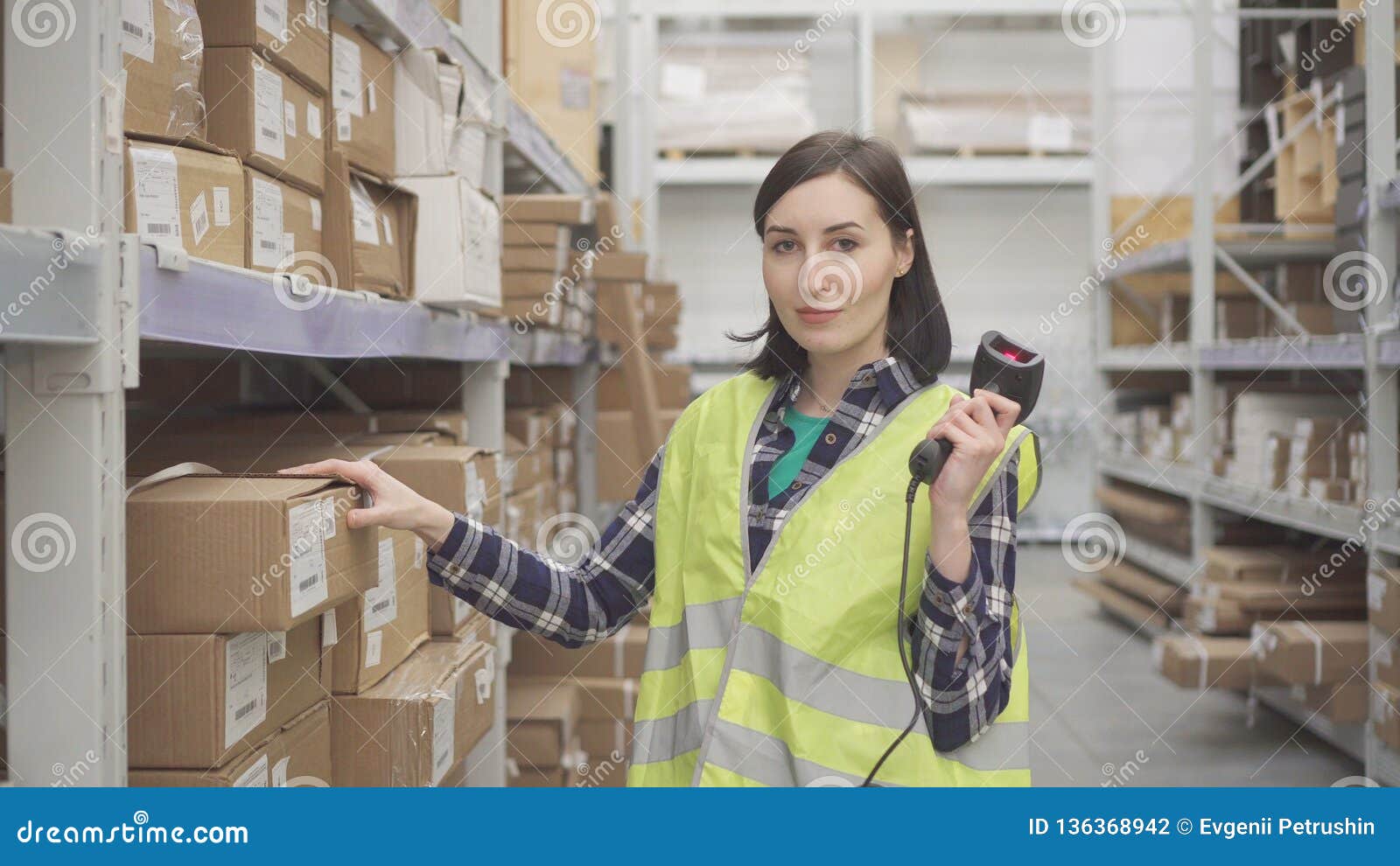 Portrait Store Worker Using Bar Code Scanner Scanning Labels on Boxes ...