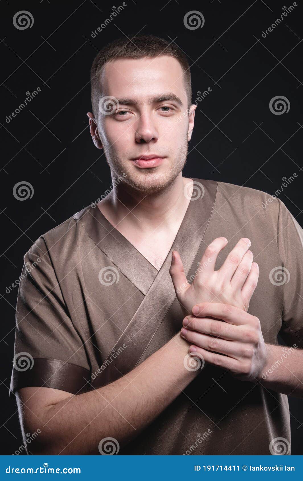 Portrait Of A Strong And Large Male Masseur In Special Clothes With A