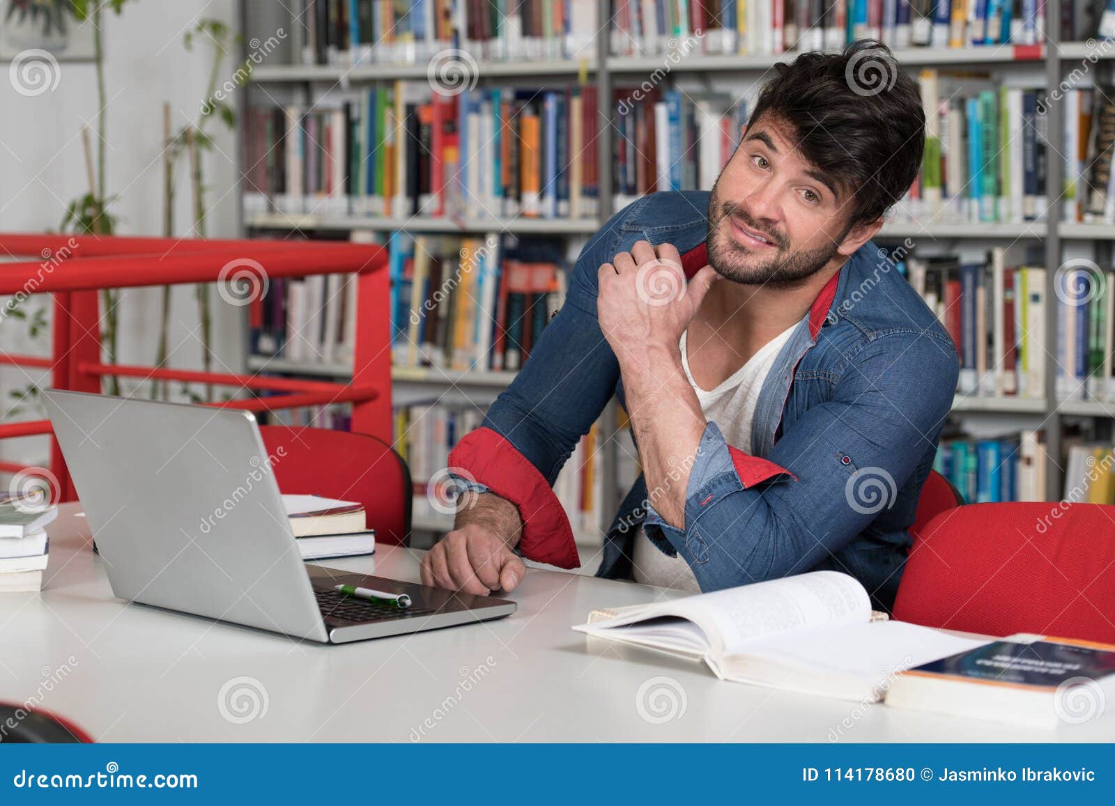 Portrait of a Student in a Library Stock Photo - Image of sitting ...
