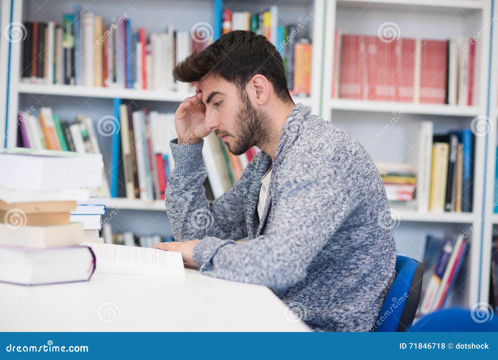 Portrait of Student while Reading Book in School Library Stock Photo ...