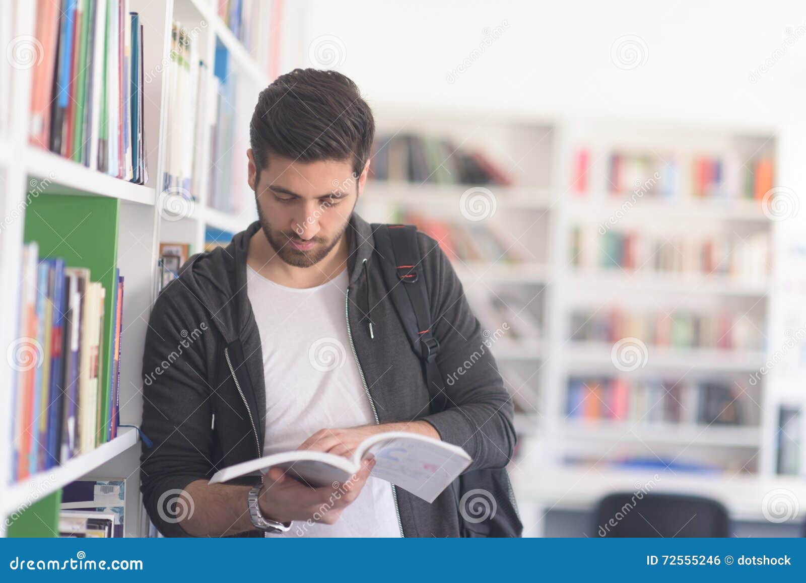 Portrait of Student while Reading Book in School Library Stock Photo ...
