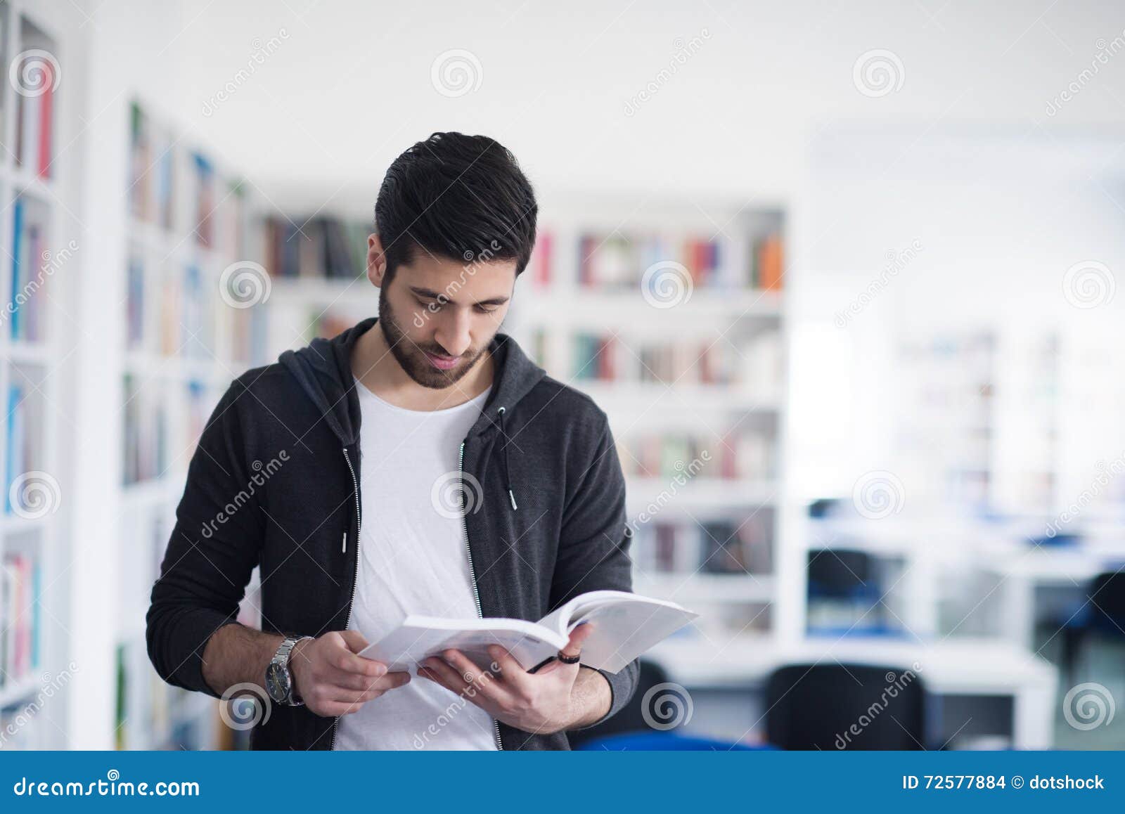 Portrait of Student while Reading Book in School Library Stock Photo ...
