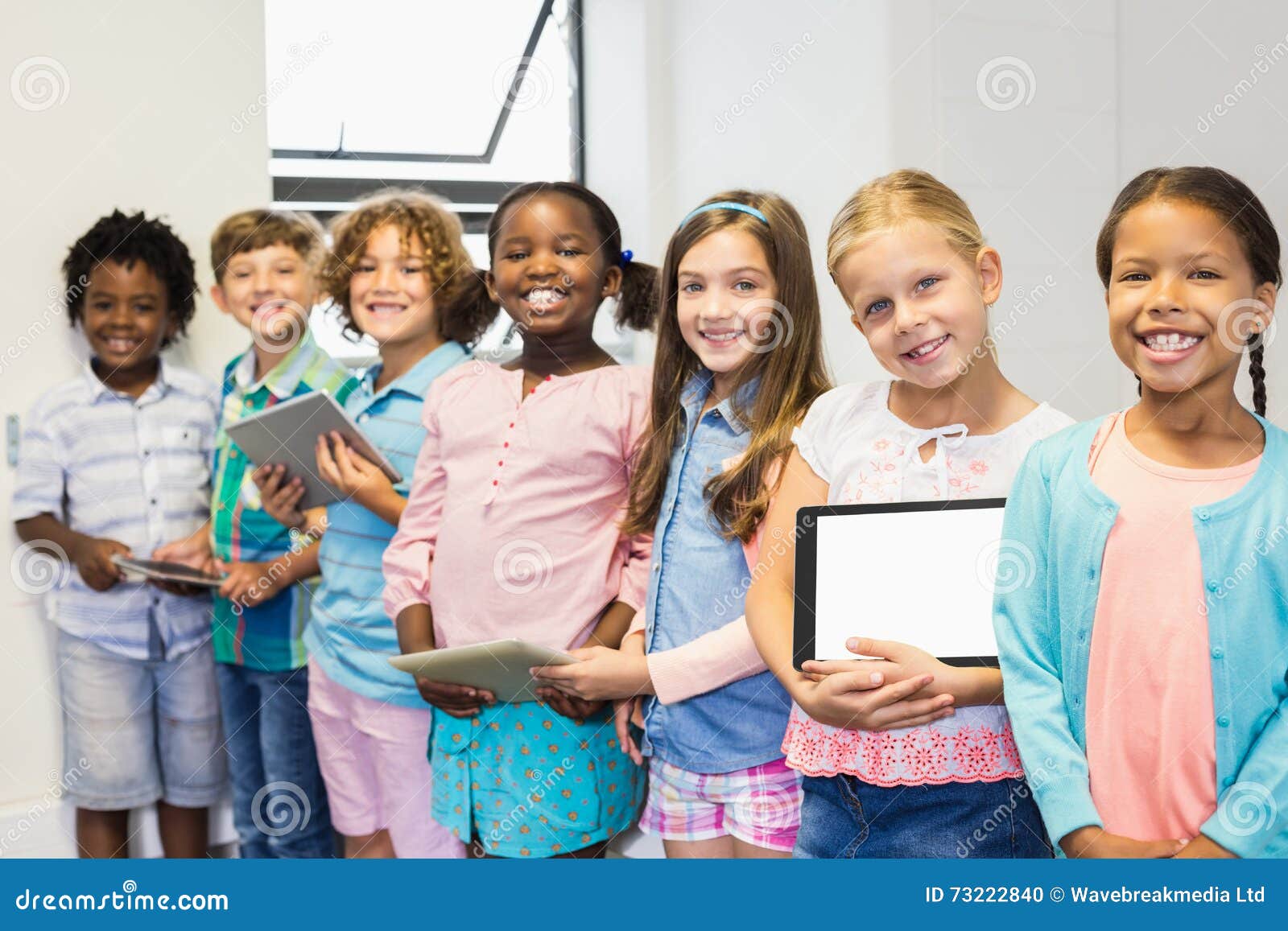 Portrait of Students Holding Digital Tablet in Classroom Stock Photo ...