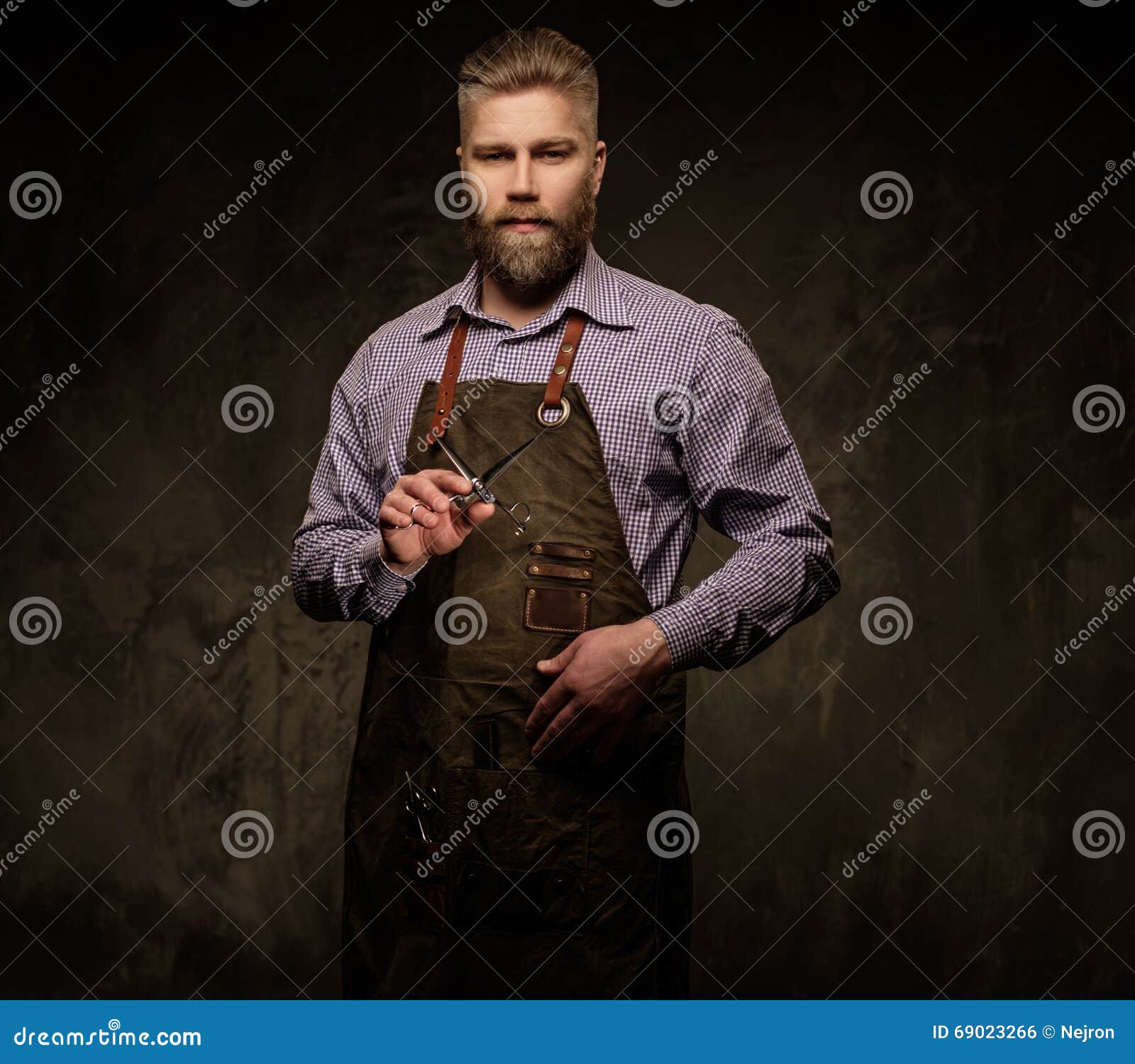 Portrait of Stylish Barber with Beard and Professional Tools on a Dark ...