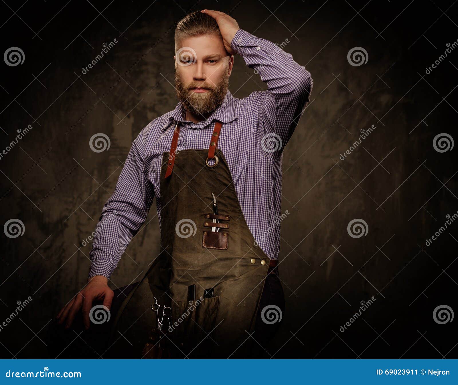 Portrait of Stylish Barber with Beard and Professional Tools on a Dark ...