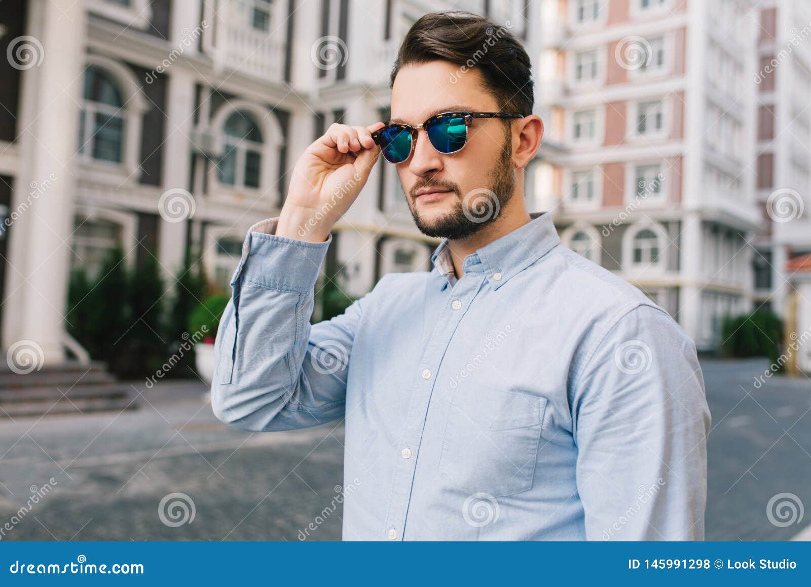 Portrait Of Stylish Dark Haired Man Walking Around British Quarter He