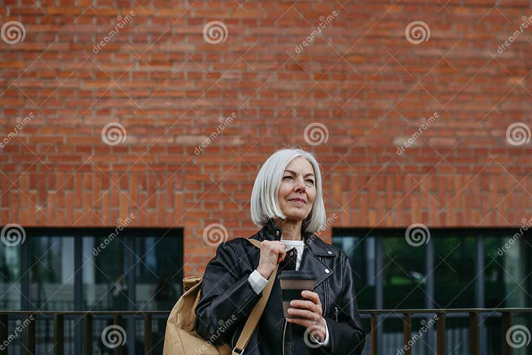 Portrait Of Stylish Mature Woman With Gray Hair On City Street Older