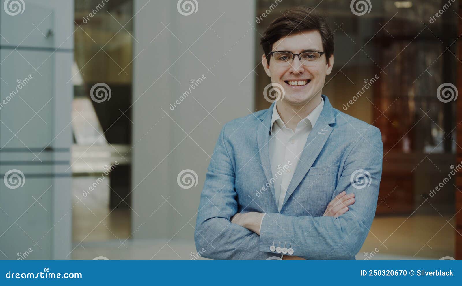 Portrait Of Successful Smiling Businessman In Glasses Looking Into