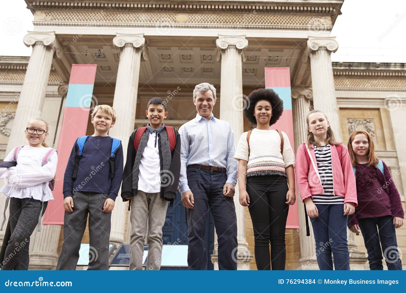 Portrait of Teacher with Class Standing Outside Museum Stock Photo ...