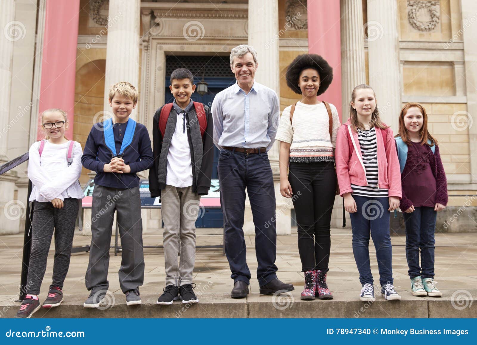 Portrait of Teacher with Class Standing Outside Museum Stock Photo ...