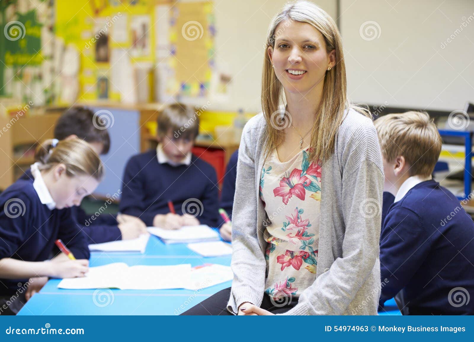 Portrait of Teacher in Classroom with Pupils Stock Image - Image of ...