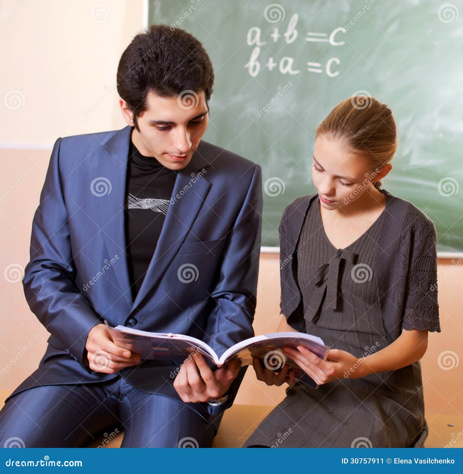 Portrait of a Teacher Explaining Something To a Smiling Schoolboy in a ...