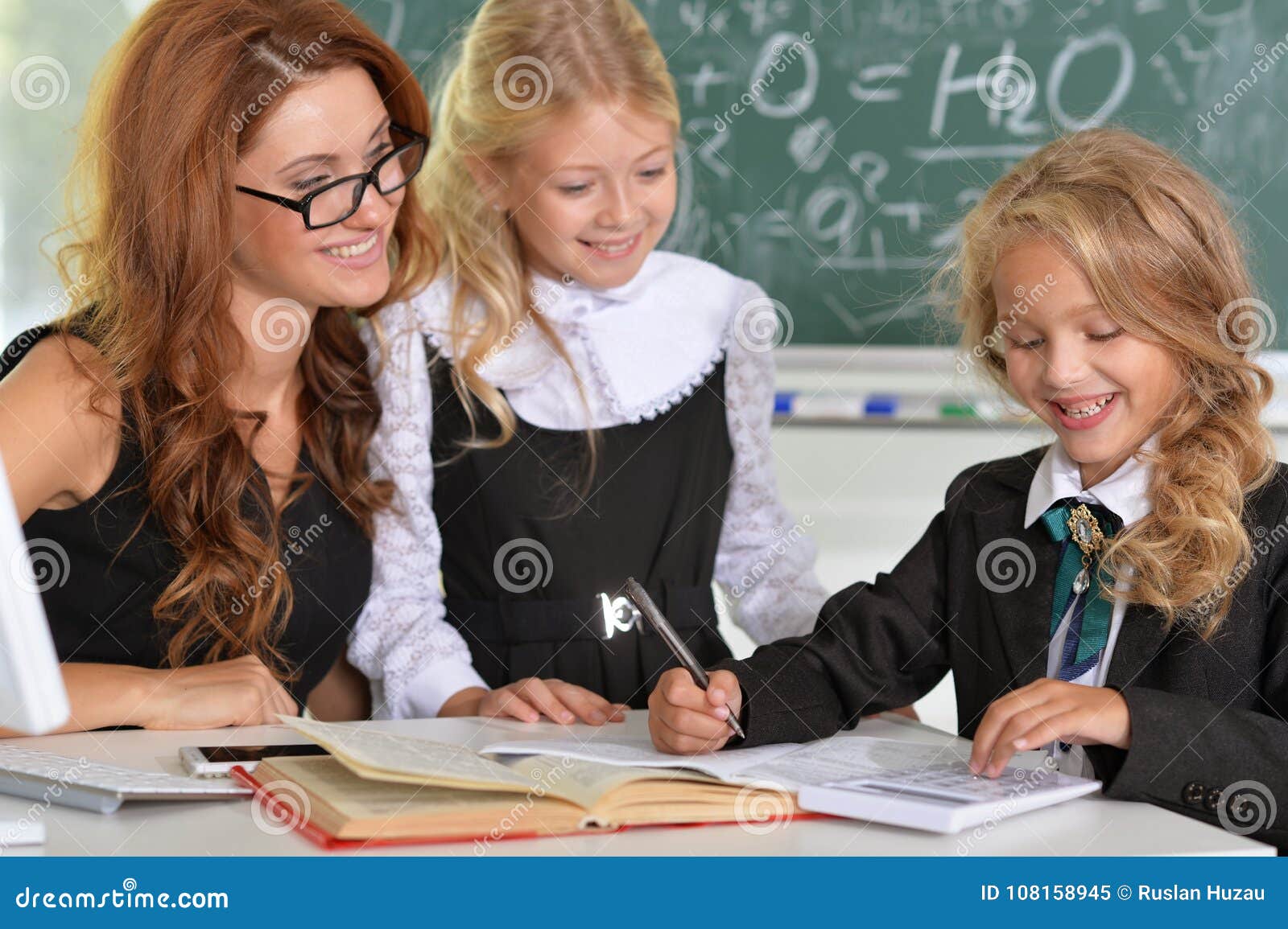 Teacher with two girls stock image. Image of lesson - 108158945