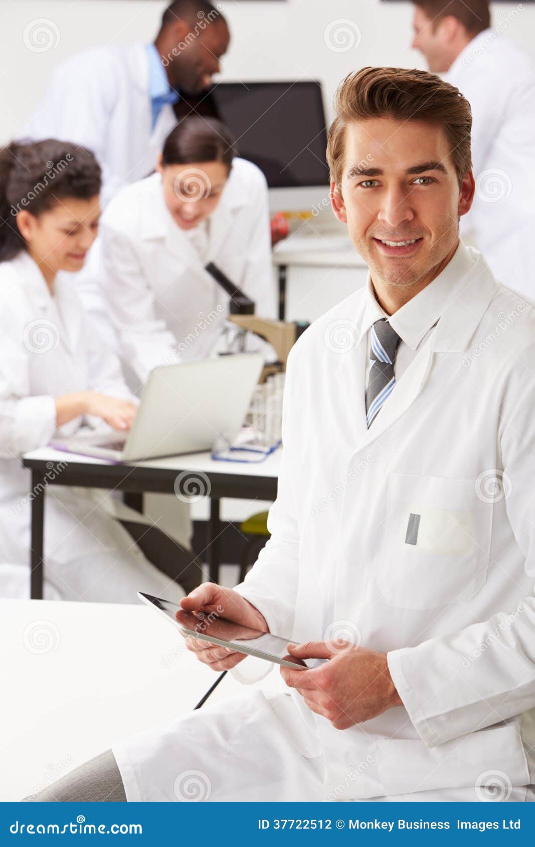 Portrait of Technician in Laboratory with Colleagues Stock Photo ...