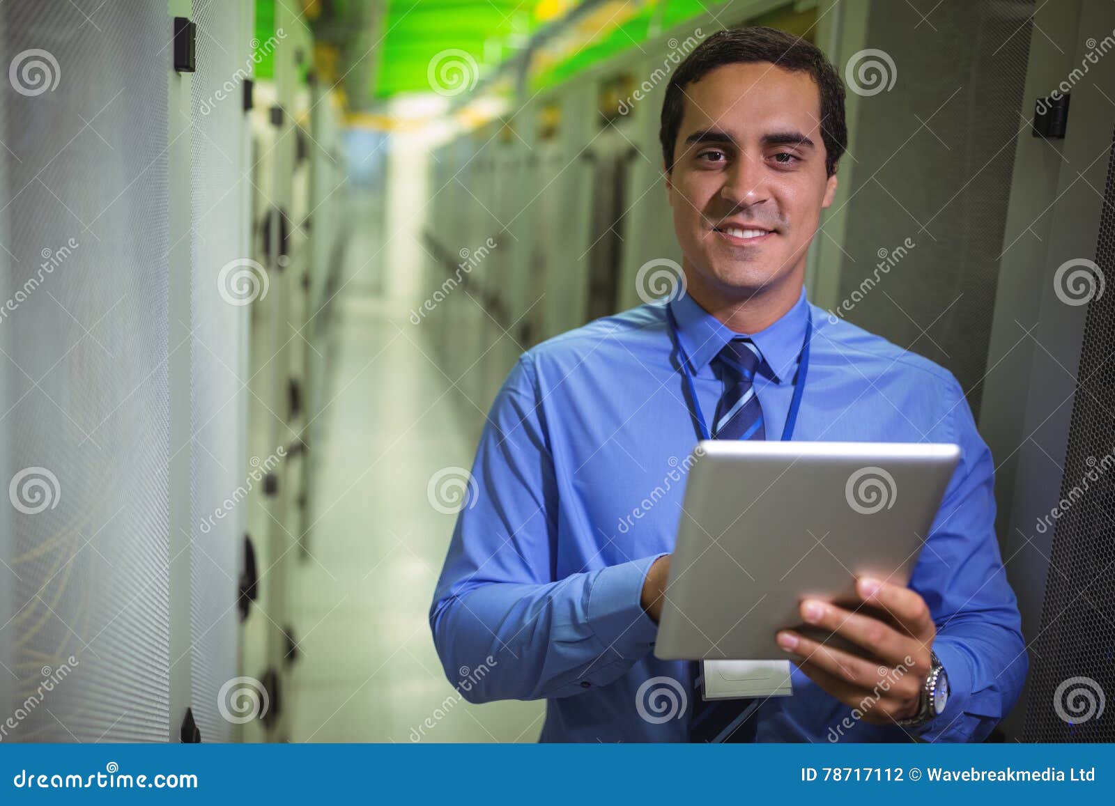 Portrait of Technician Using Digital Tablet in Hallway Stock Photo ...