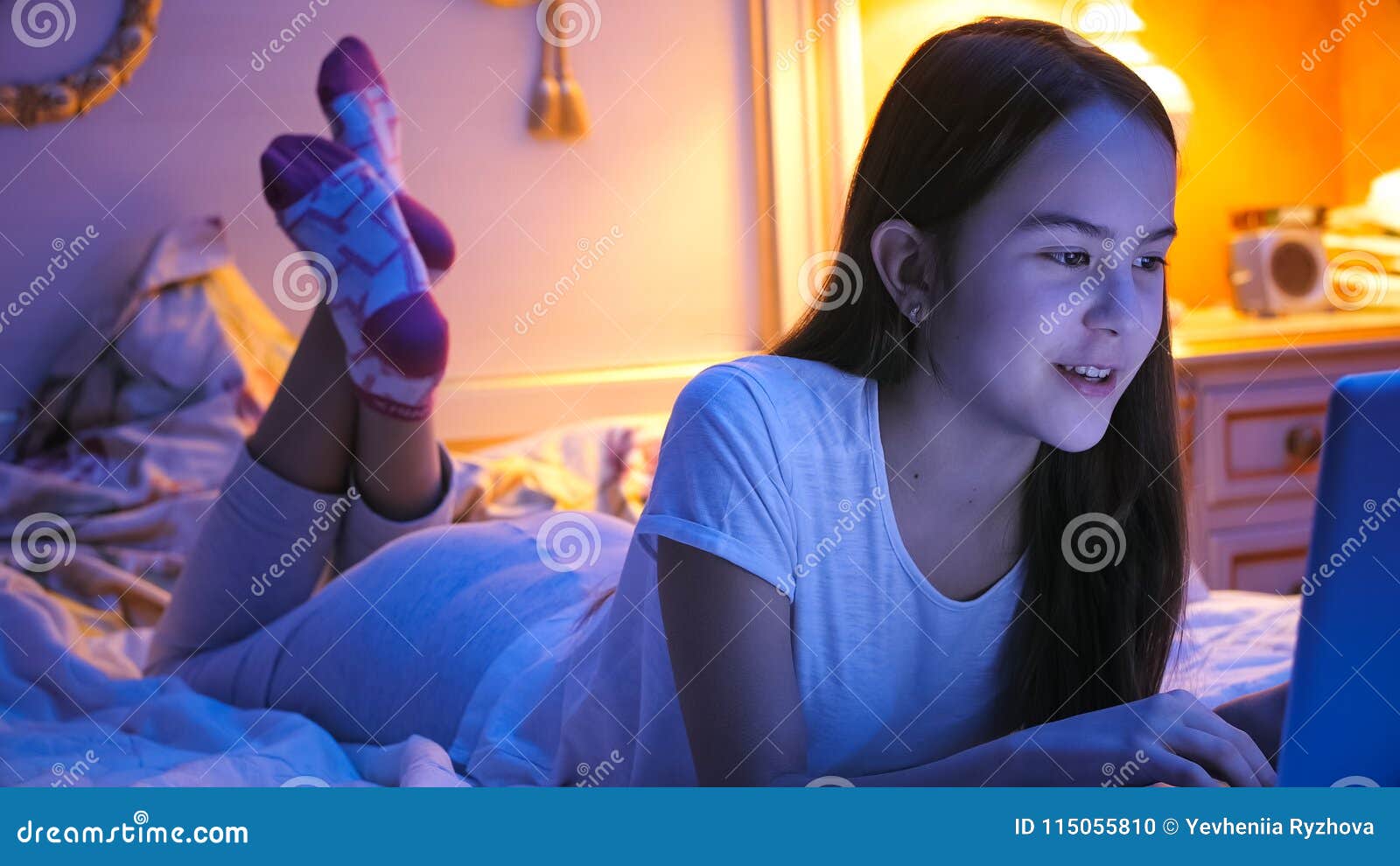 Portrait of Teenage Girl Lying on Bed at Night and Chatting in the ... Portrait of Teenage Girl Lying on Bed at Night and Chatting in the ...