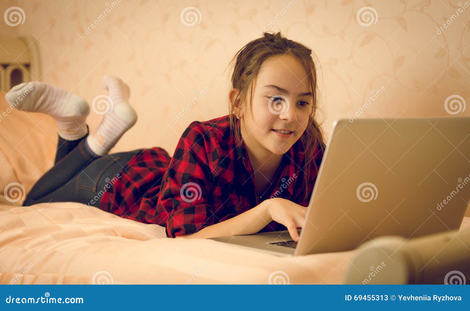 Portrait of Teenage Girl Lying on Bed and Using Laptop Stock Image ... Portrait of Teenage Girl Lying on Bed and Using Laptop Stock Image ...
