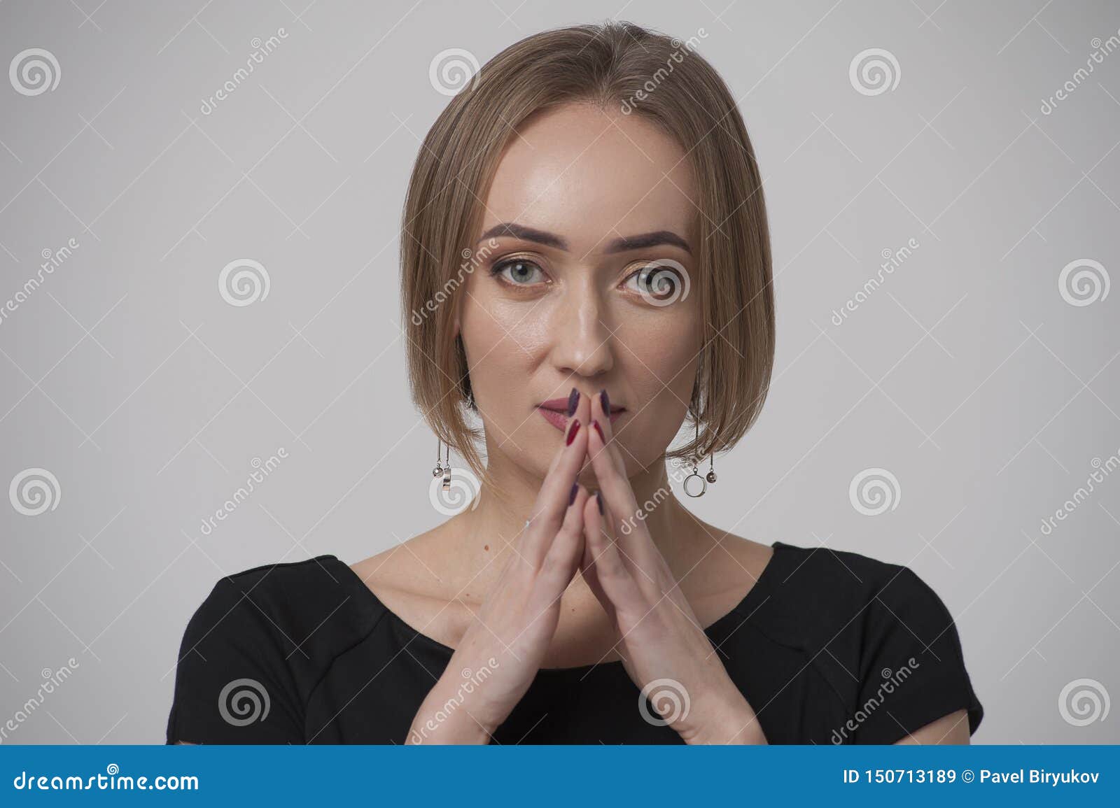 Portrait Of Thoughtful Young Woman Pointing Her Fingers To Lips Stock ... Portrait Of Thoughtful Young Woman Pointing Her Fingers To Lips Stock ...