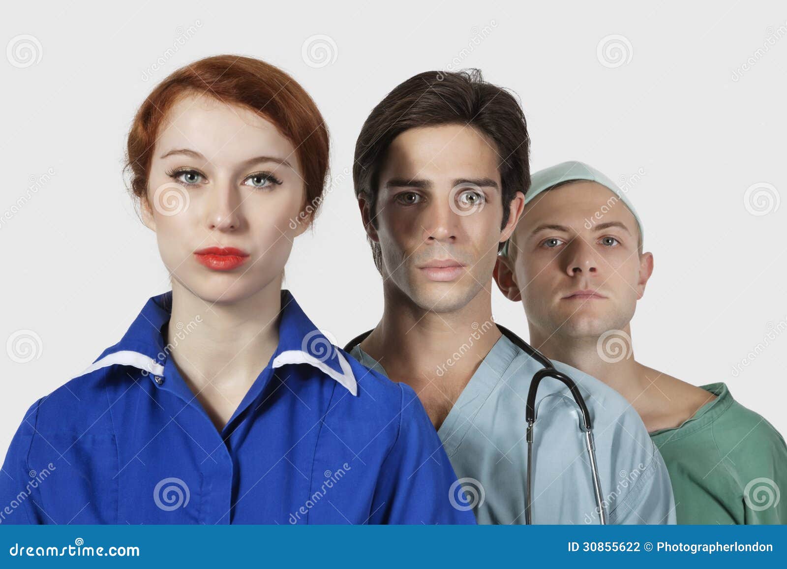Portrait Of Three Confident Medical Practitioners Against Gray ...