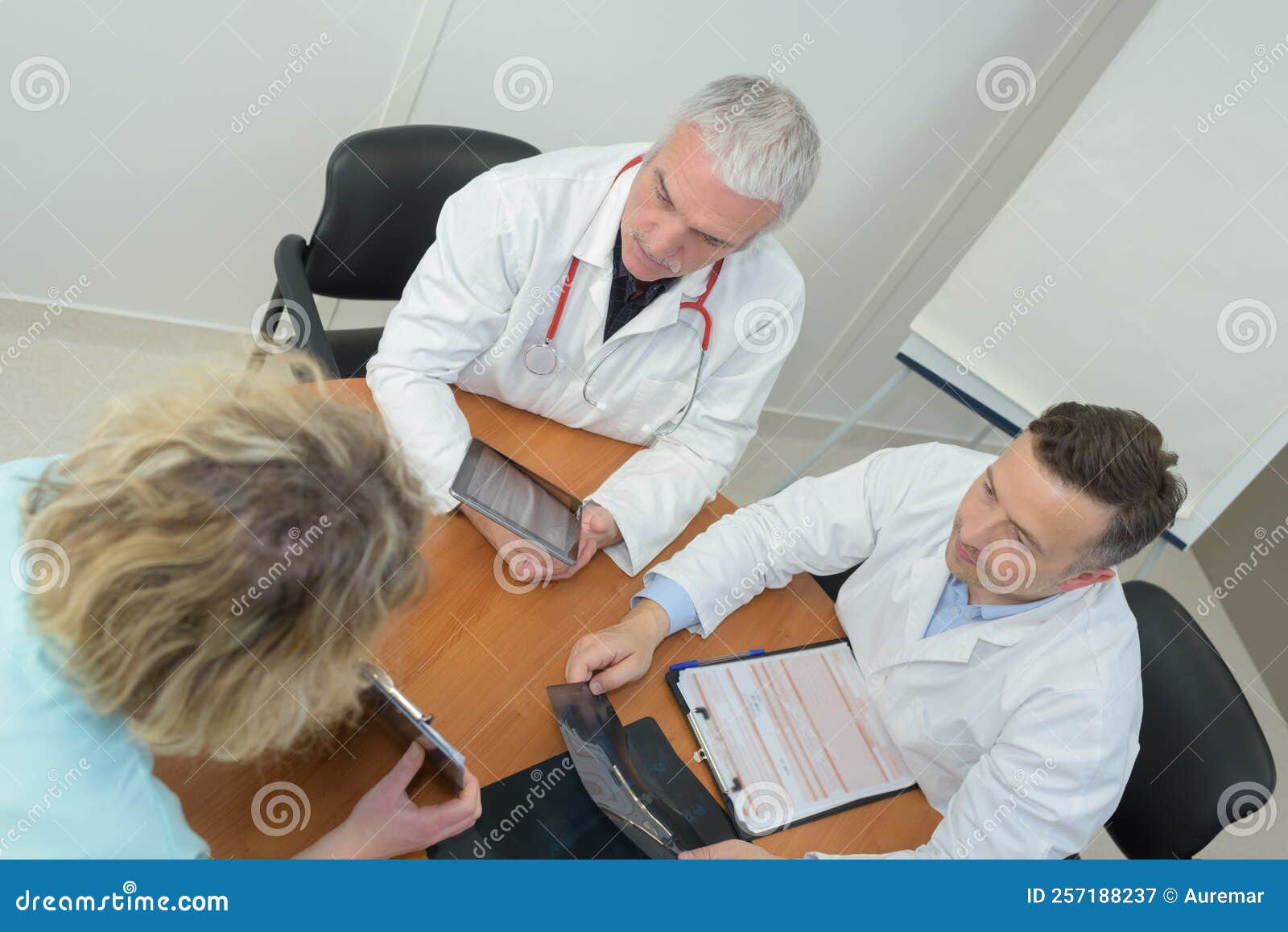 Portrait three doctors stock image. Image of thumbs - 257188237