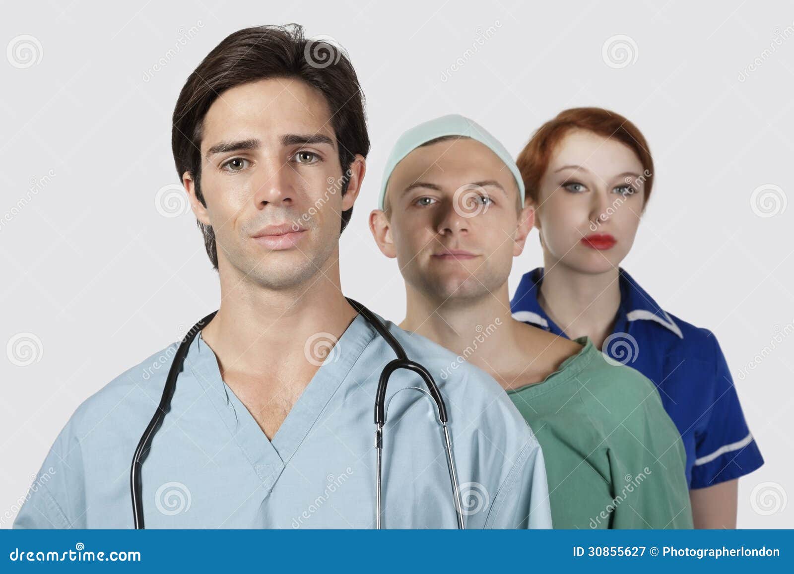 Portrait of Three Medical Practitioners Against Gray Background Stock ...