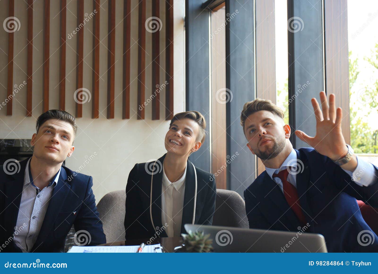Portrait of Three Partners Discussing Ideas at Meeting. Stock Photo ...