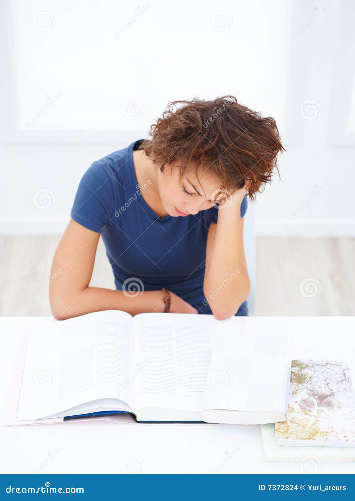 Portrait of a Tired Looking Student Reading Book Stock Photo - Image of ...