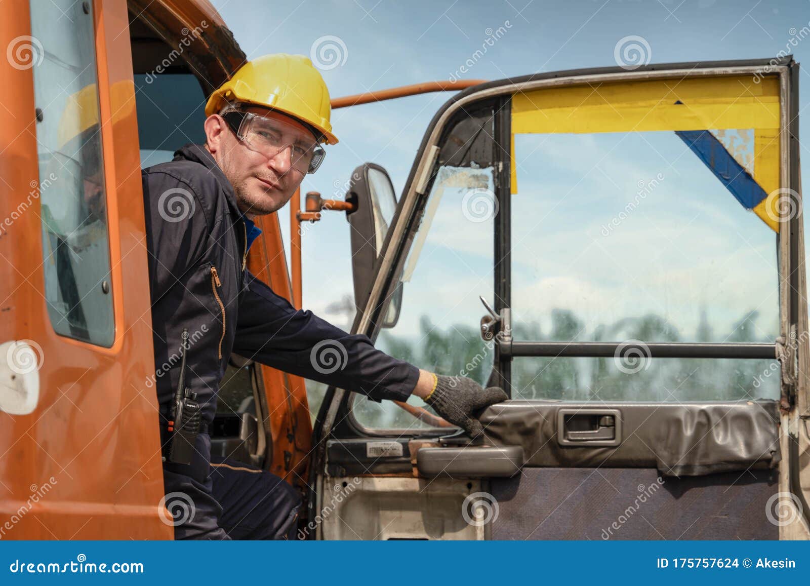 Portrait of Truck Driver in Yellow Truck at Construction Site Stock ...