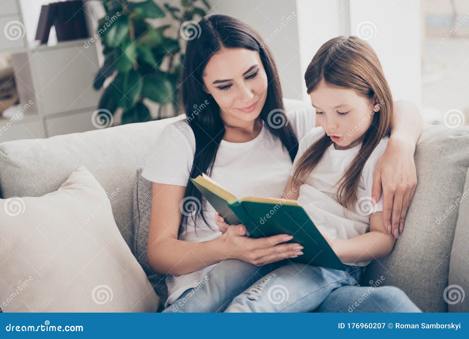 Lovely Caring Mother Hugging Her Adorable Daughter While Sitting In