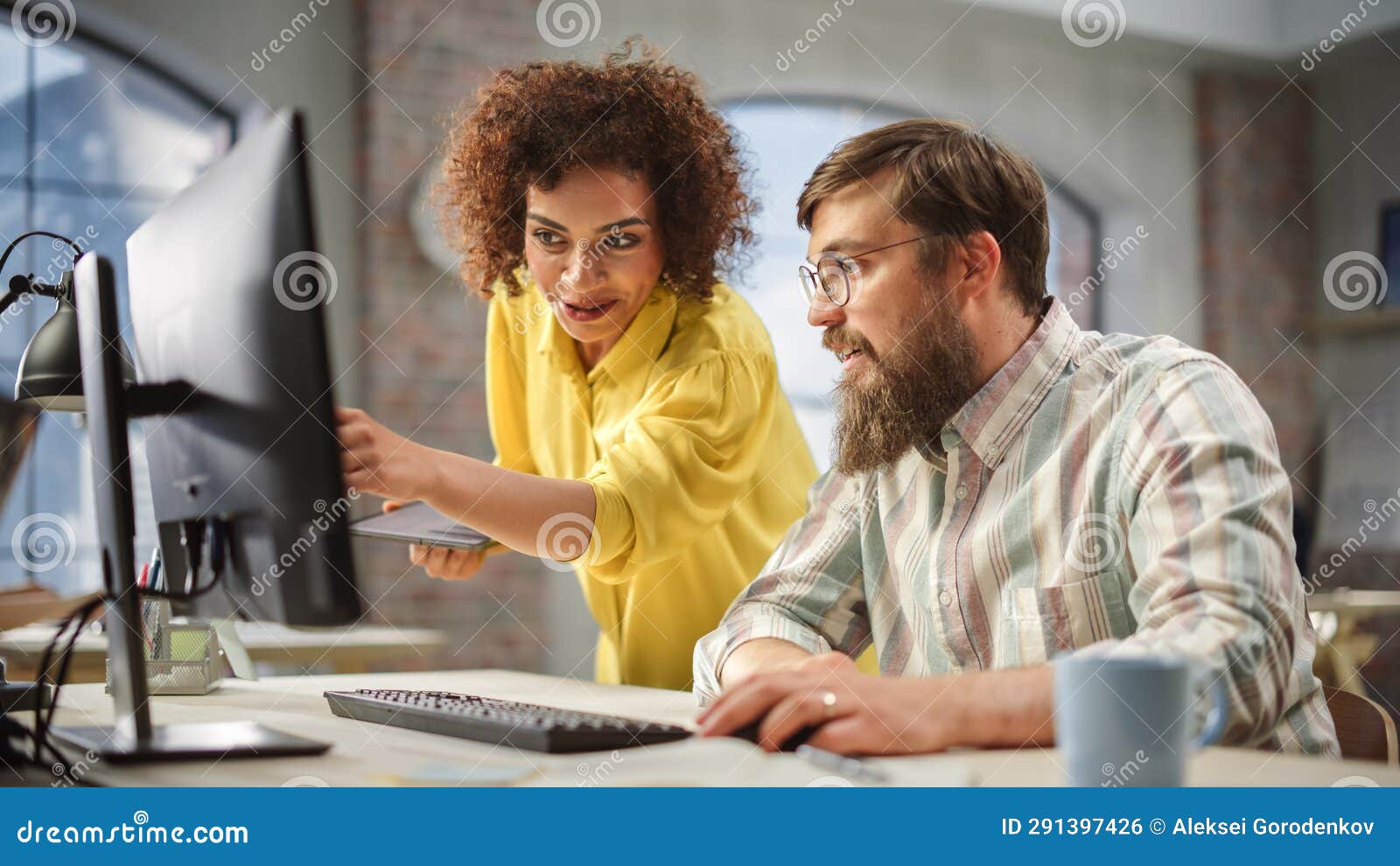 Portrait of Two Creative Colleagues Collaborating and Pointing at the ...