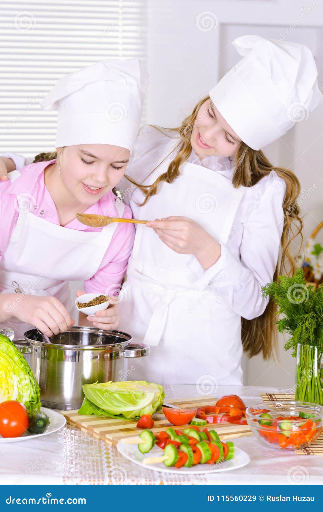 Two cute girls cooking stock image. Image of children - 115560229
