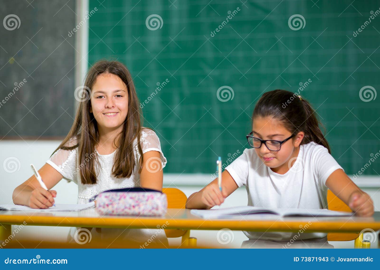 Portrait Of Two Happy Schoolgirls In A Classroom Royalty-Free Stock ...