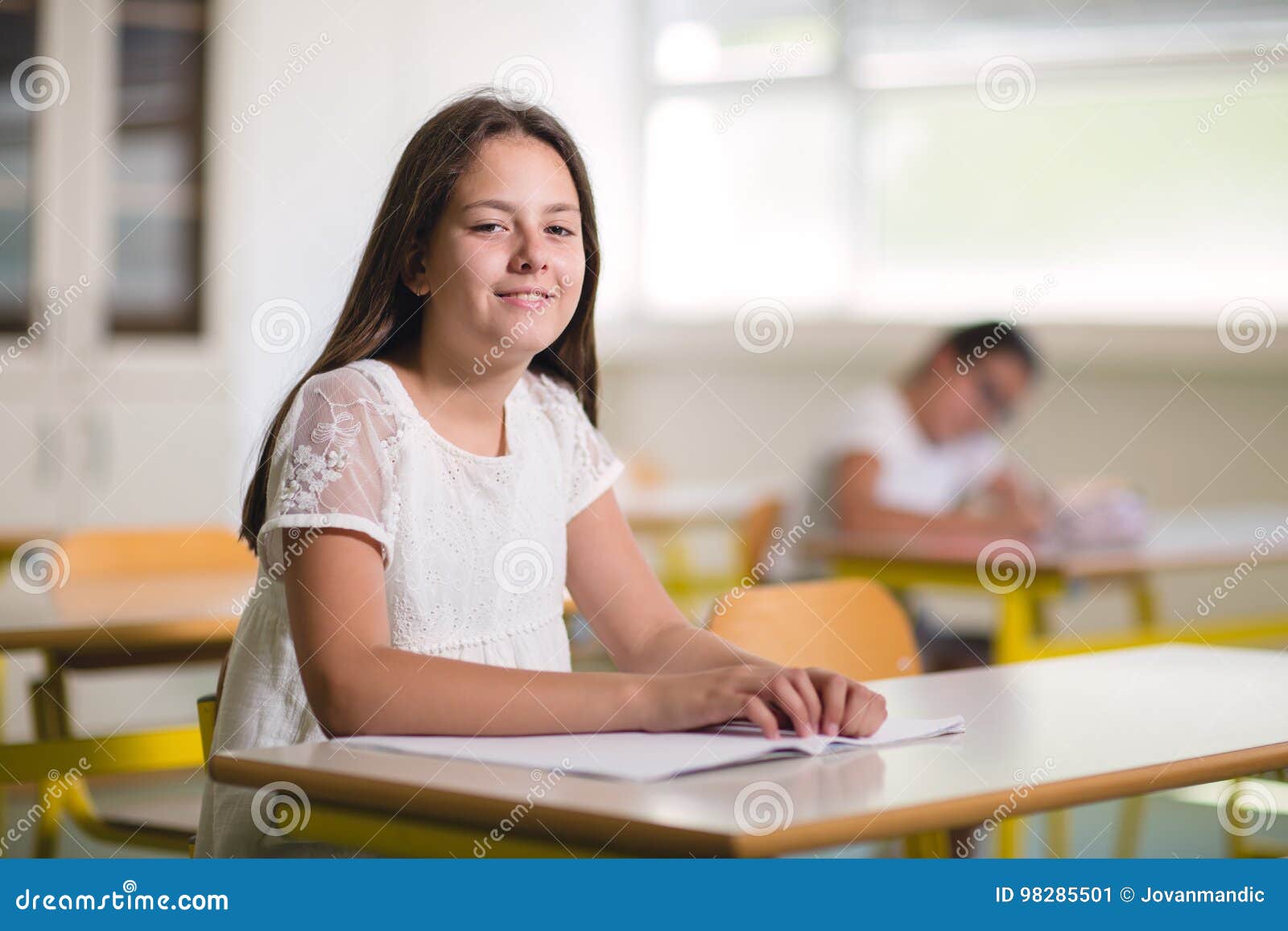 Portrait Of Schoolgirls Standing With Classmate With Classmates In ...
