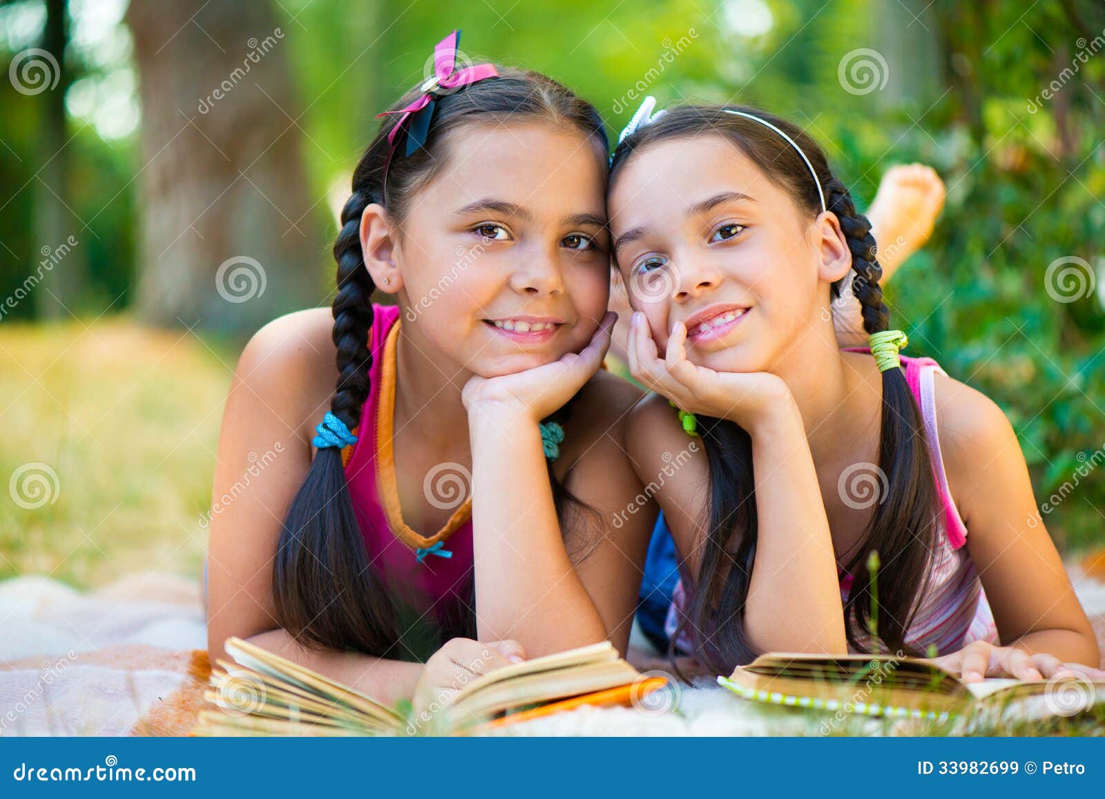 Portrait of Two Hispanic Sisters Reading in the Park Stock Image ...