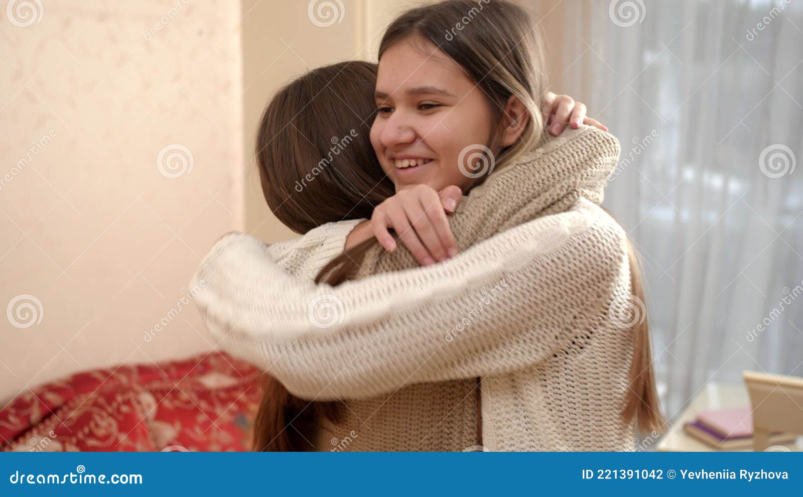 Portrait Of Two Laughing Girls Hugging And Embracing Each Other Stock