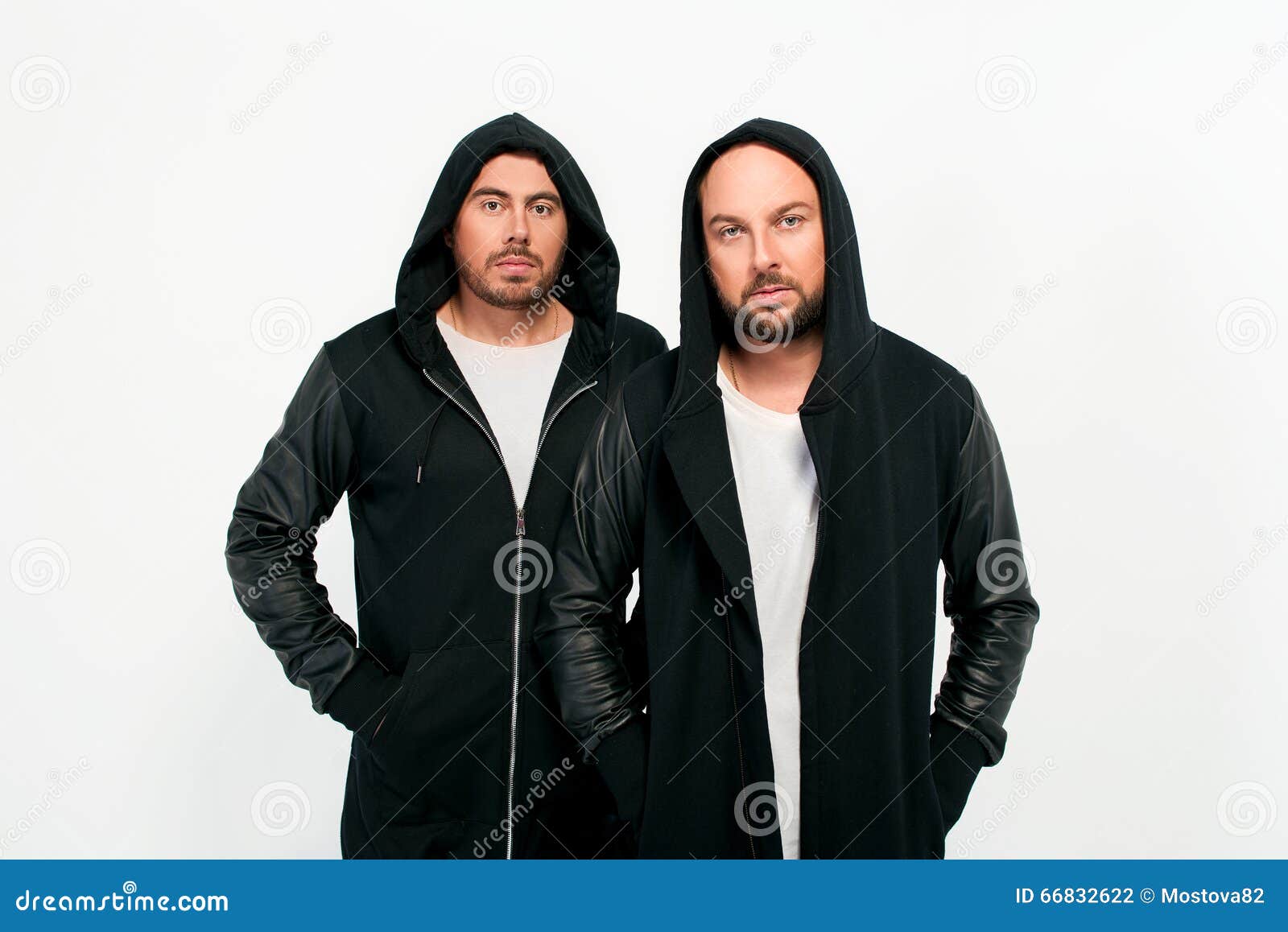 Portrait of Two Men in Black Jackets and Hoods Stock Photo - Image of ...