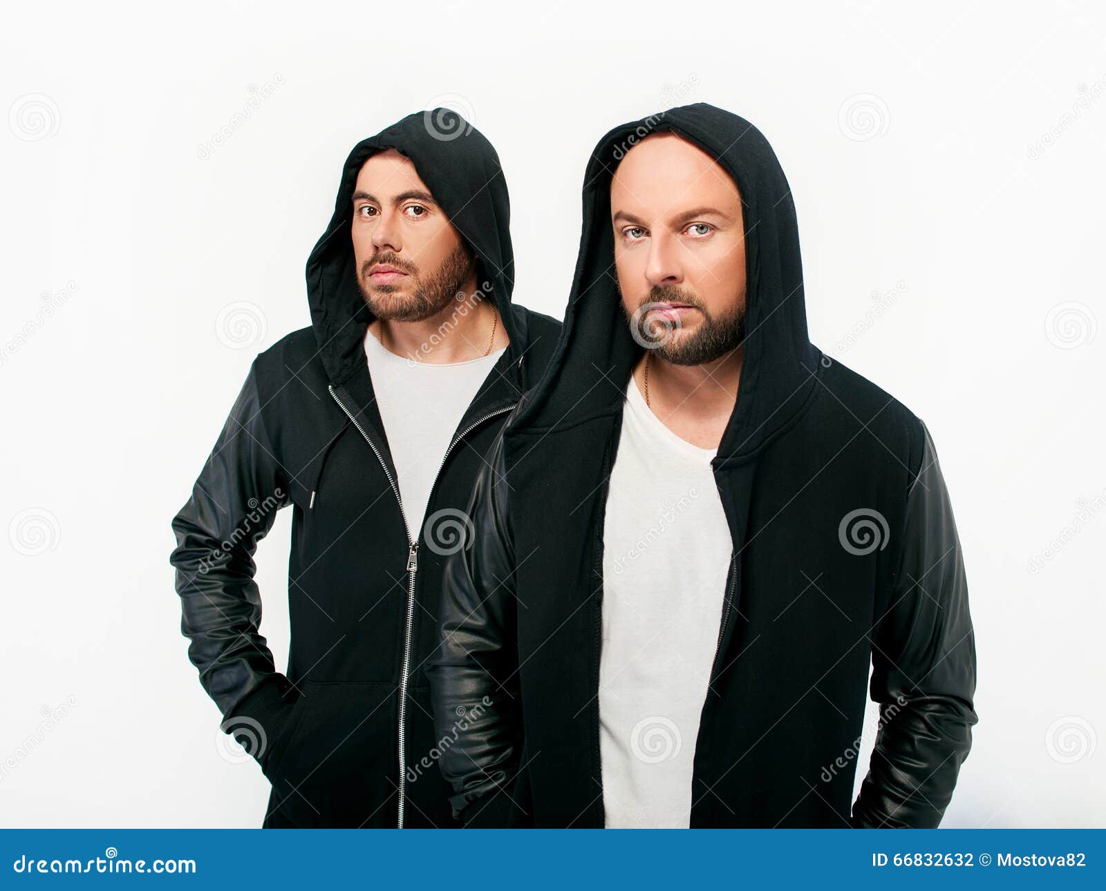 Portrait of Two Men in Black Jackets and Hoods Stock Photo - Image of ...