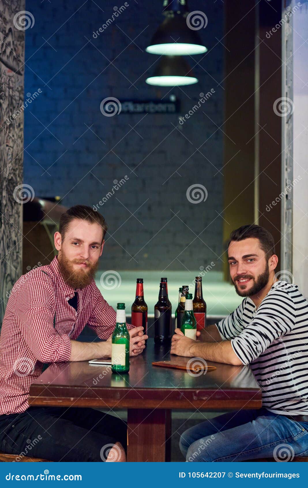 Two Buddies Drinking Beer in Bar Stock Image - Image of contemporary ...