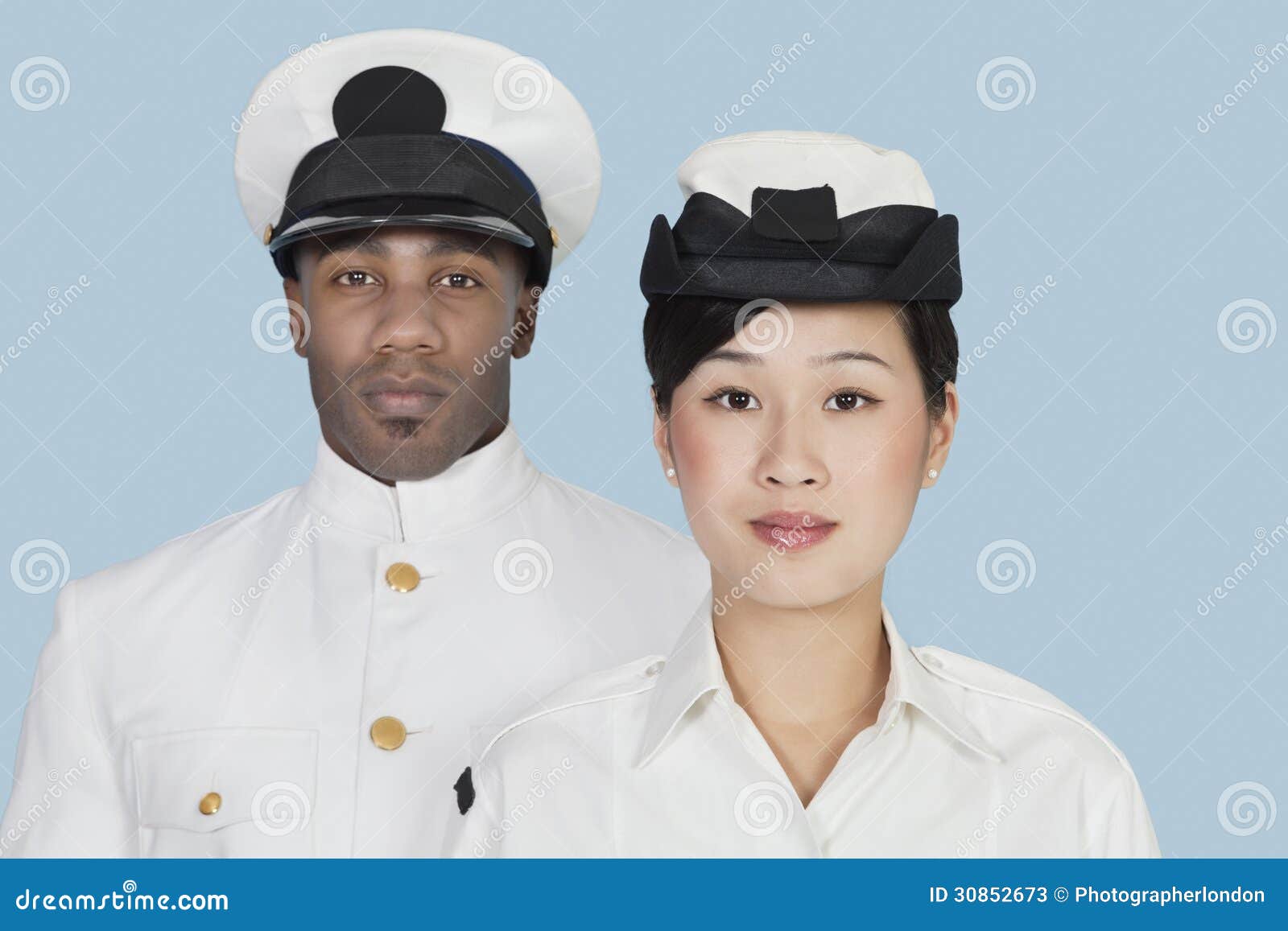 Portrait of Two Multi-ethnic US Navy Officers Over Light Blue ...