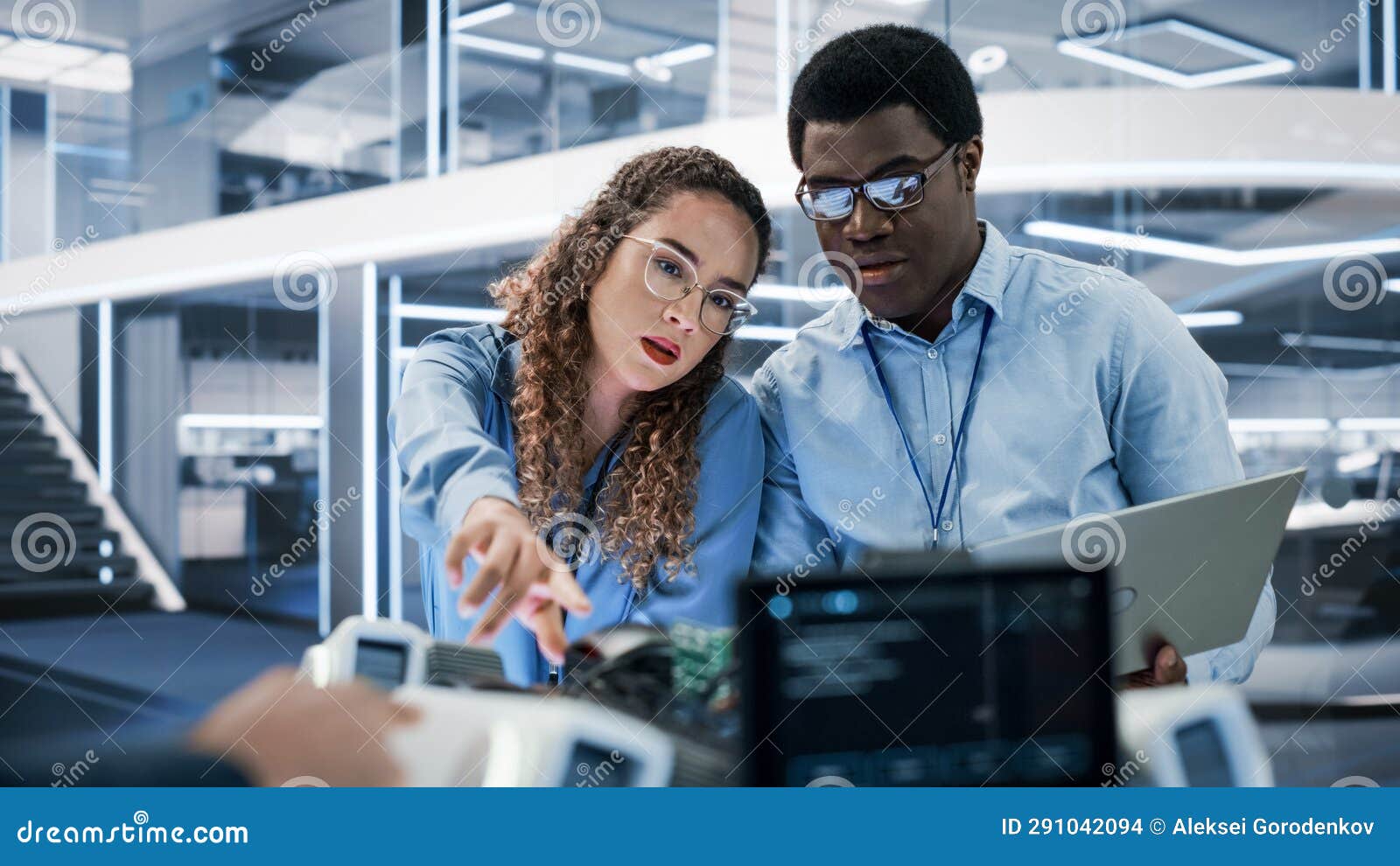 Portrait of Two Multicultural Industrial Robotics Engineers Using ...