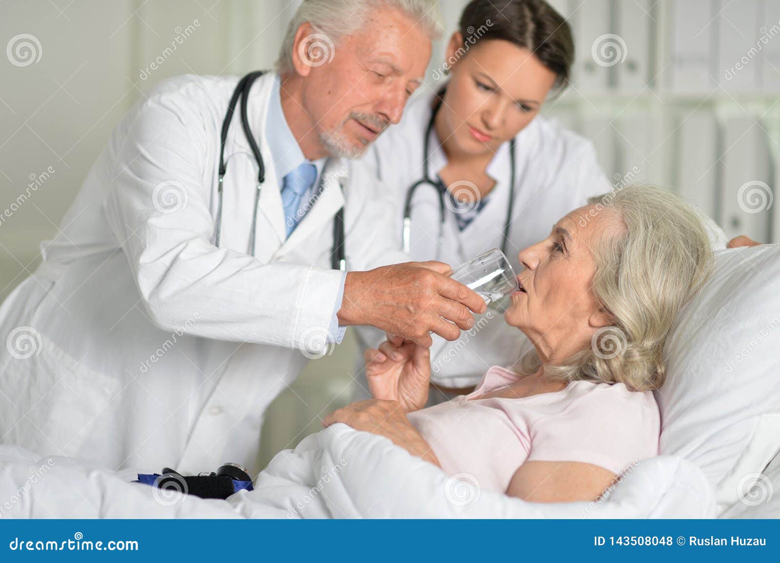 Portrait of Two Professional Doctors Inspecting Patient Stock Photo ...