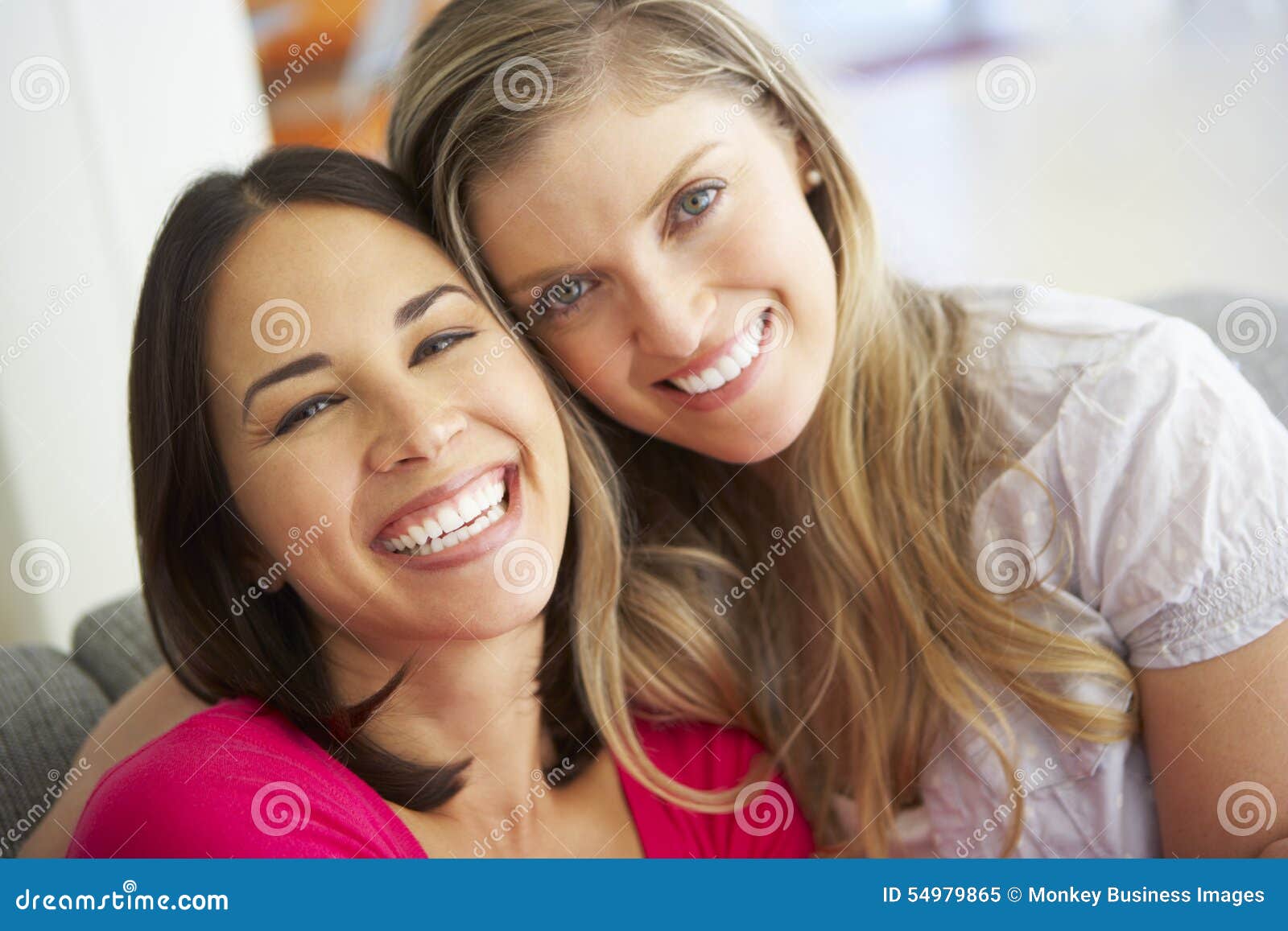 Portrait of Two Smiling Female Friends on Sofa Stock Image - Image of ...