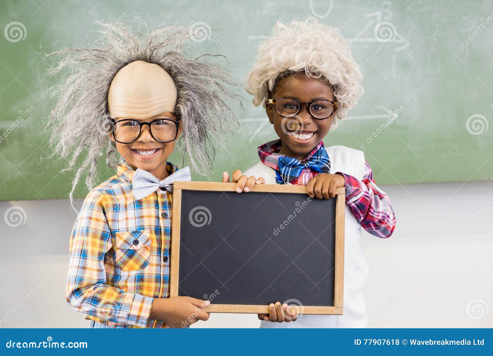 Portrait of Two Smiling School Kids Holding Slate in Classroom Stock ...