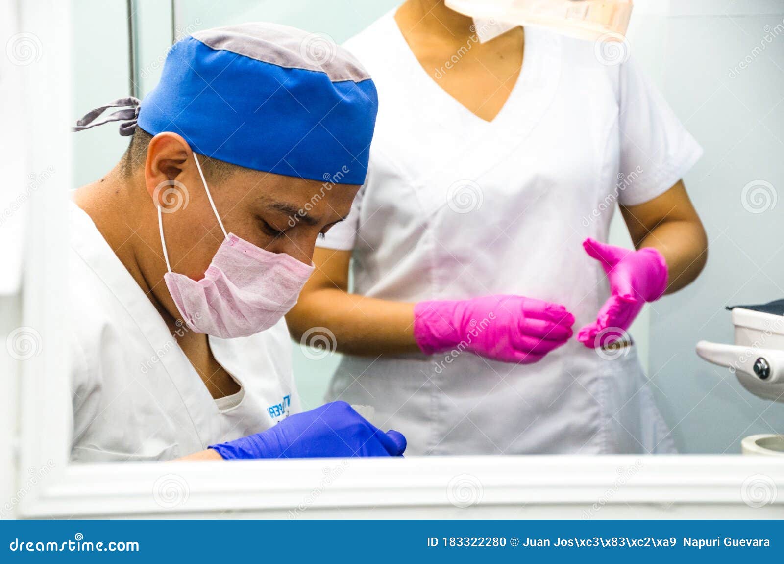 Portrait of Two Surgeons at Work, Operating in Uniform, Looking at the ...