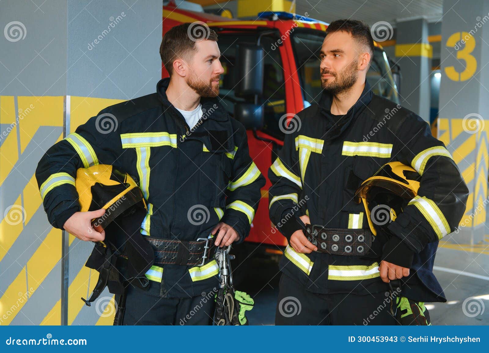 Firemen Un Uniform Standing Behind Fire Tape And Many Fire Engine ...