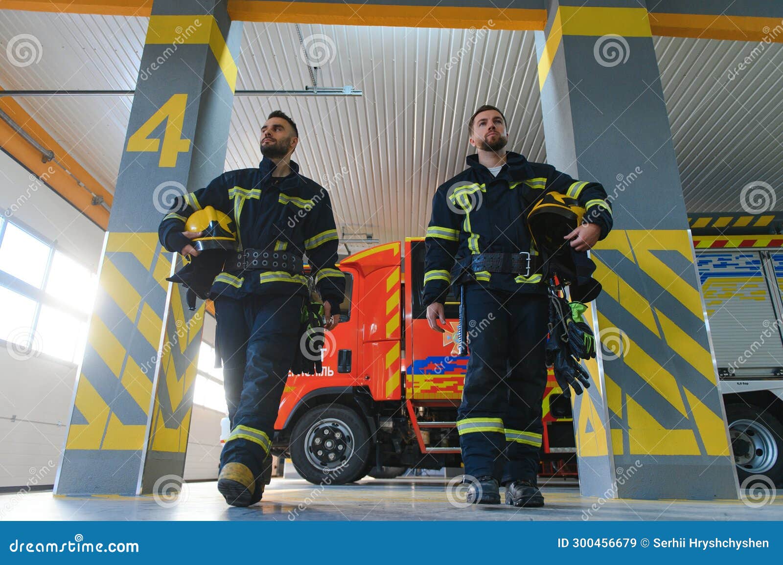 Firemen Un Uniform Standing Behind Fire Tape And Many Fire Engine ...