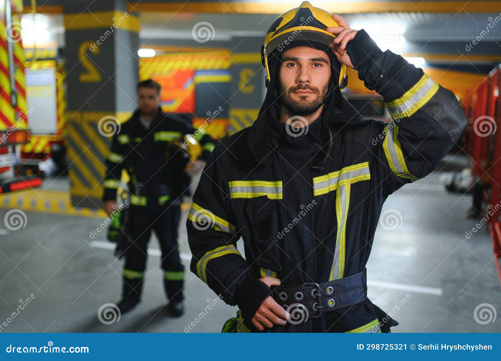 Portrait of Two Young Firemen in Uniform Standing Inside the Fire ...